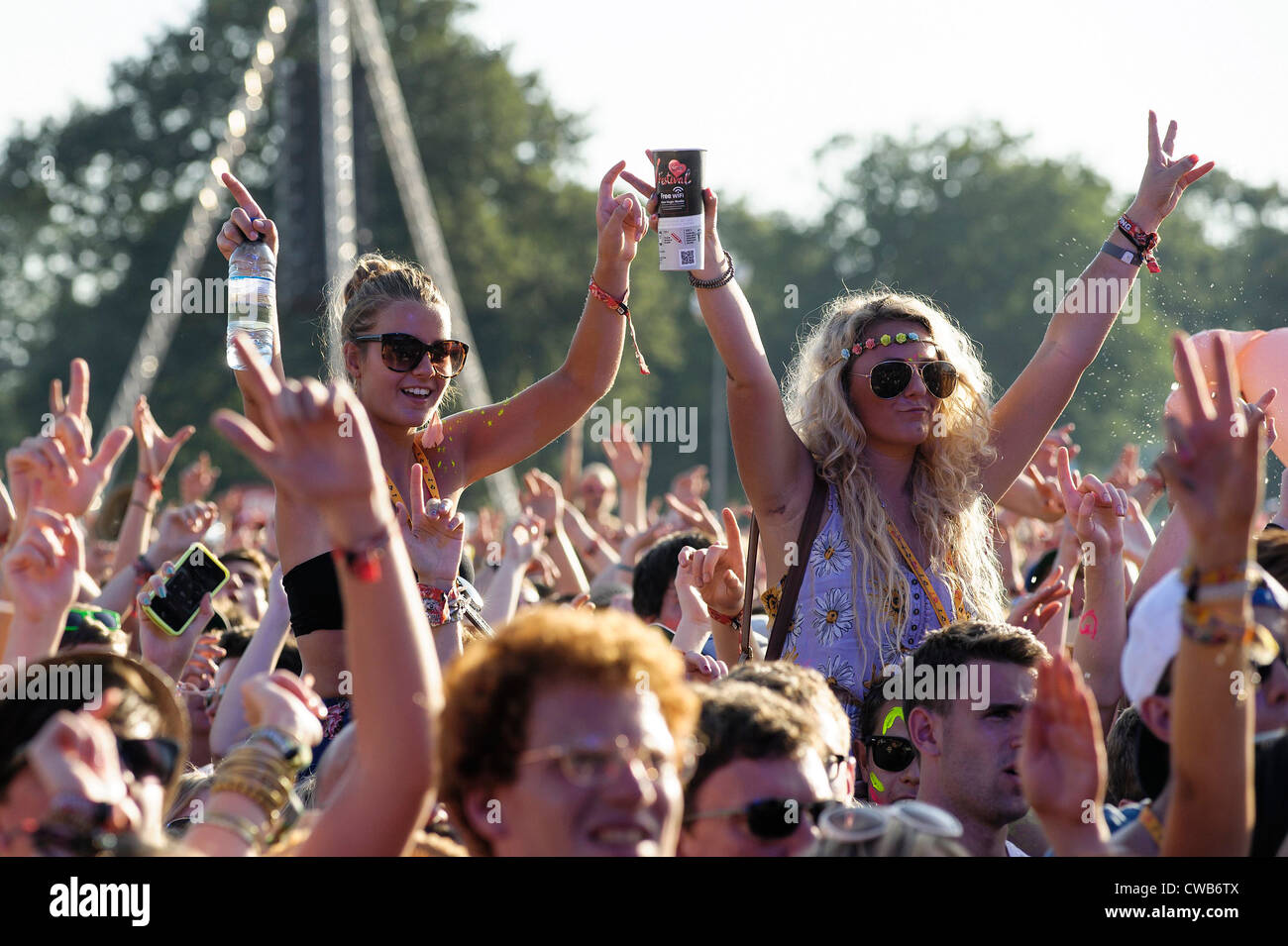 2 young female music fans in the crowd on shoulders at V Festival ...