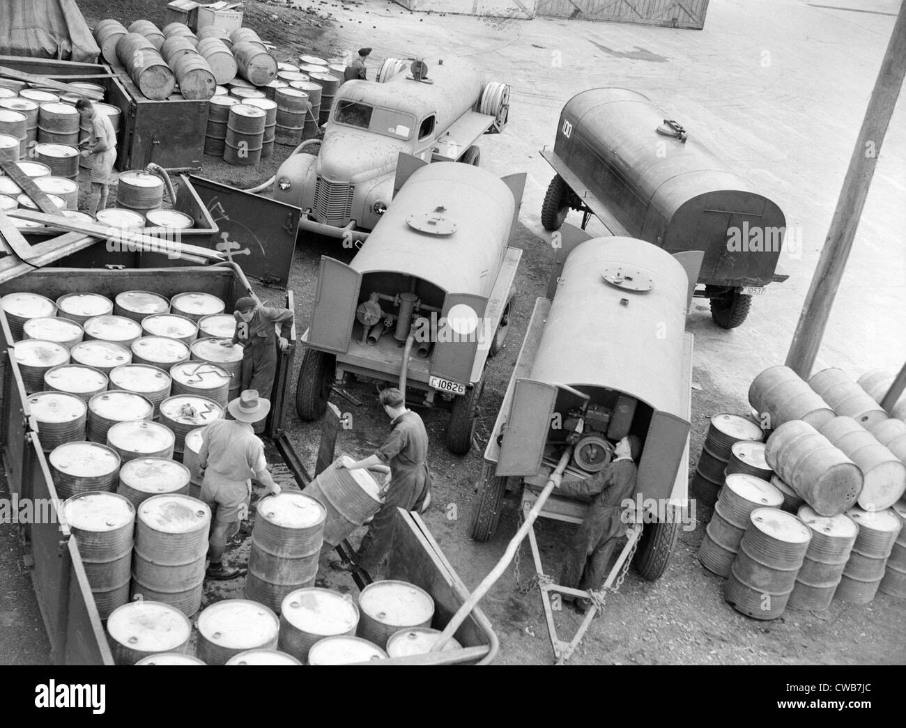 World War II. American Lend-lease gasoline being transferred from drums ...