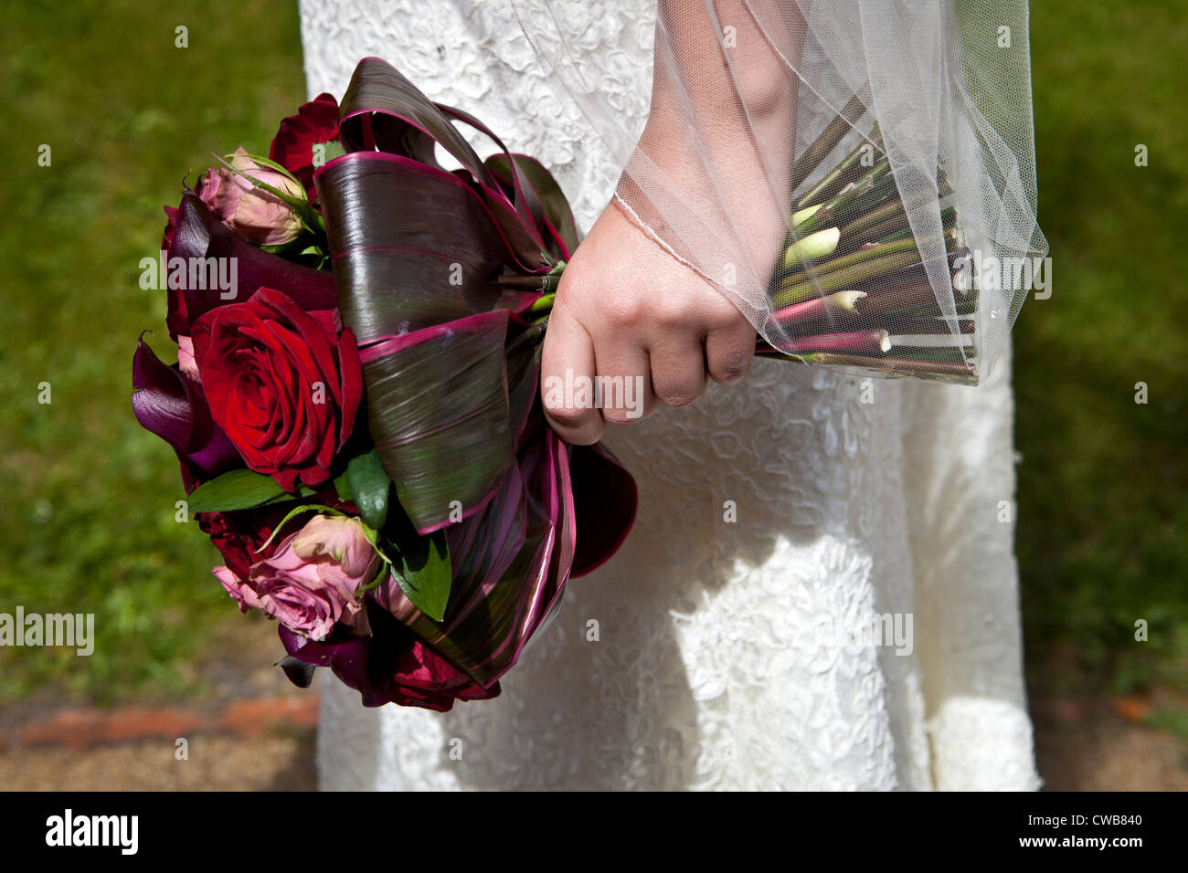 Bride holding wedding bouquet Stock Photo - Alamy