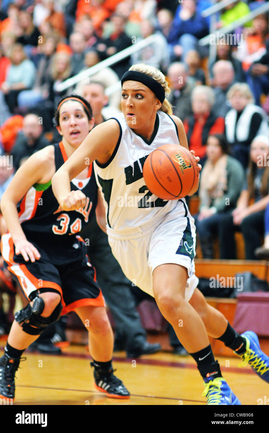 Basketball player driving toward the basket and along the baseline and ...