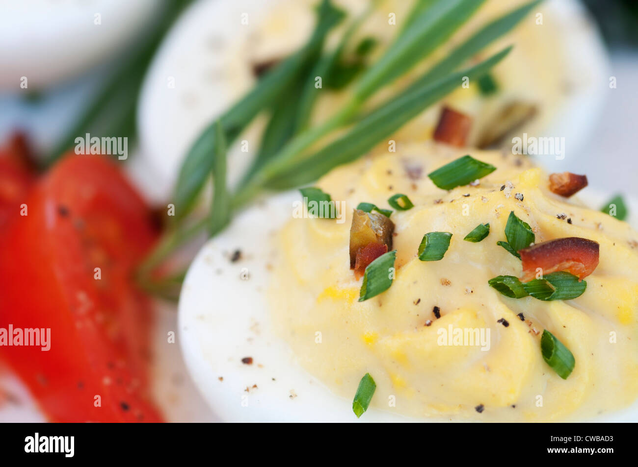 Decorative piped filling in deviled eggs with vegetable and herb ...