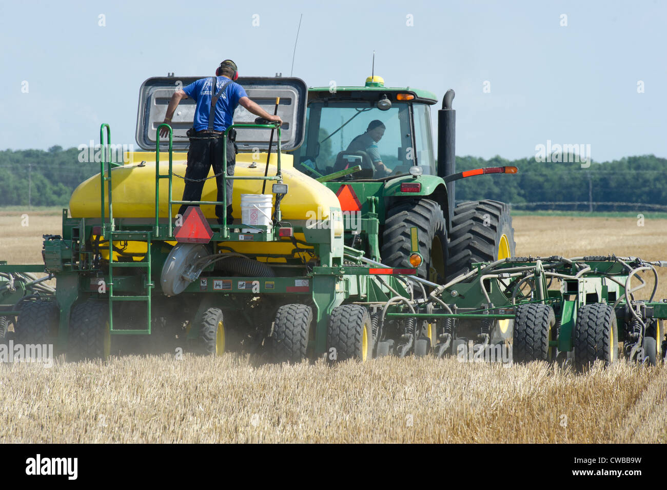 Tractor plowing through field of farm Stock Photo - Alamy