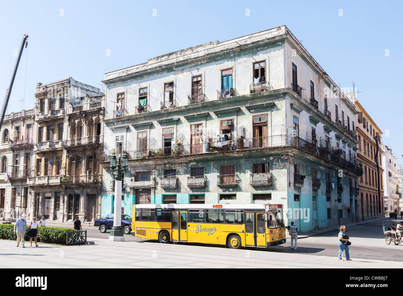 Buildings and yellow coach in front of a run down apartment block in ...