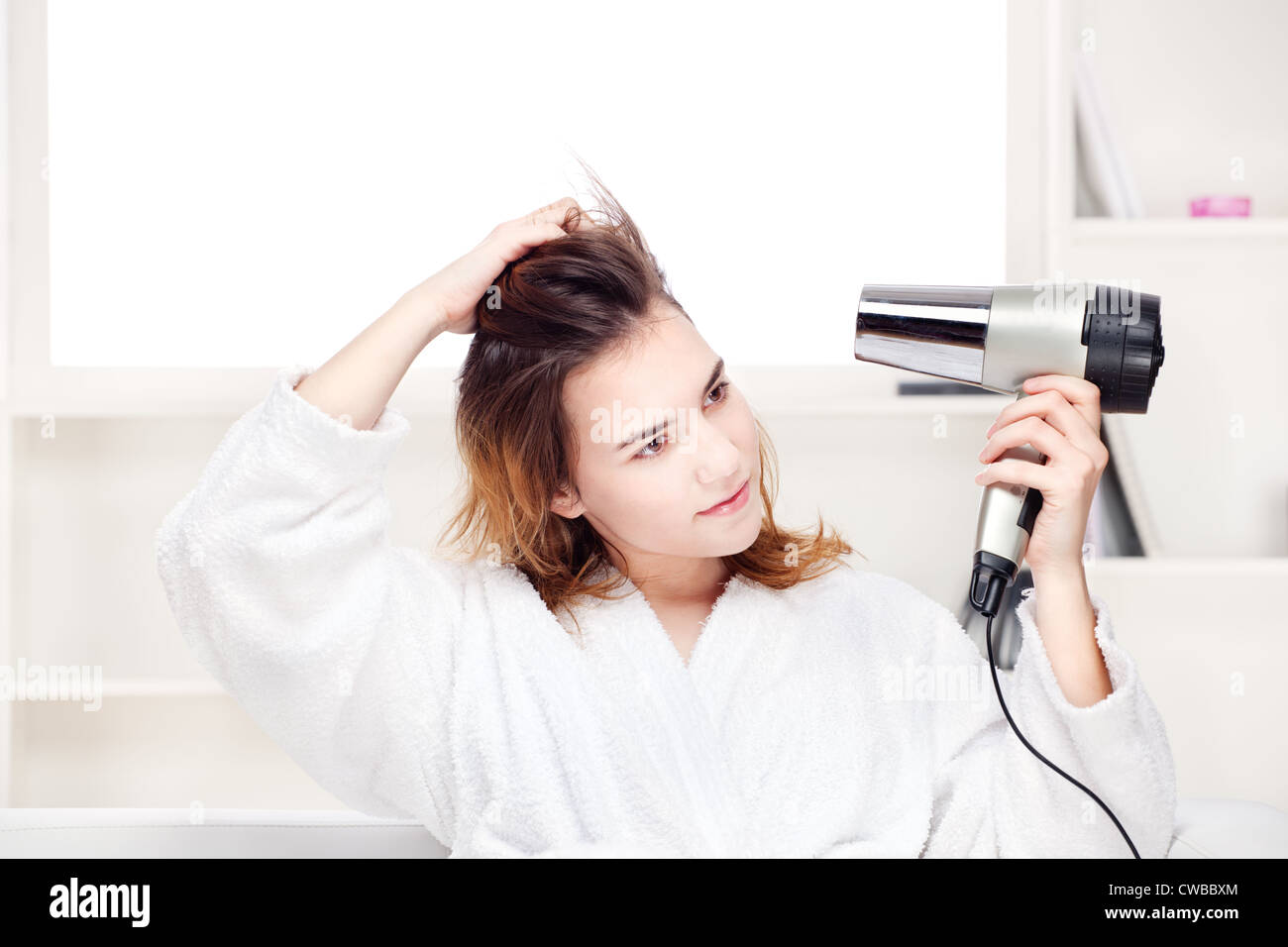 Teenage girl drying her hair at home Stock Photo - Alamy