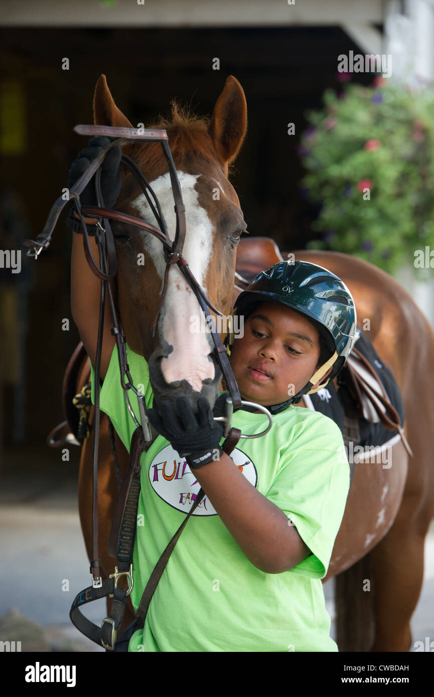 Horseback riding at equestrian stables Stock Photo - Alamy