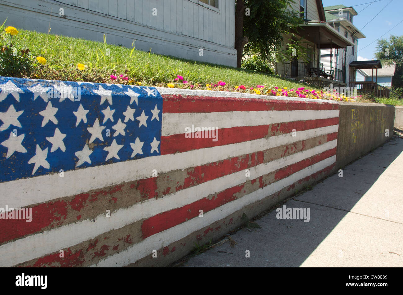 An American Flag is painted on a sidewalk barrier in Flint, MI Stock ...