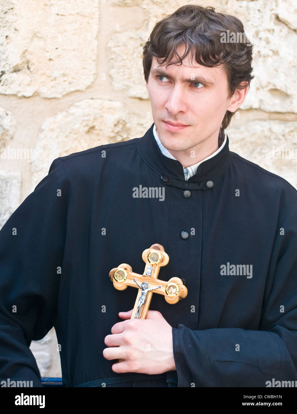 Russian Orthodox monk carry across along the Via Dolorosa in Jerusalem ...