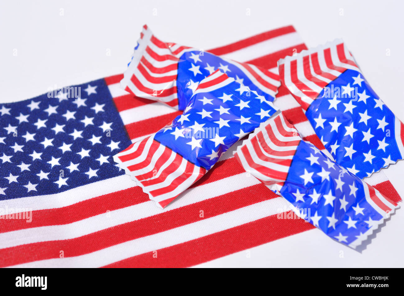 Candy wrapped in US flag wrapper laying on US flag Stock Photo - Alamy