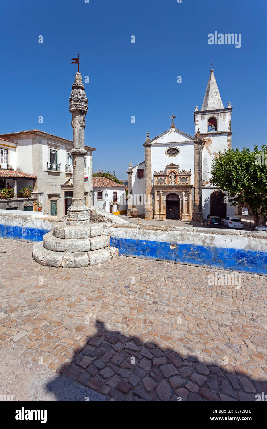 Obidos Town Pillory and Santa Maria Church seen from Direita Street ...