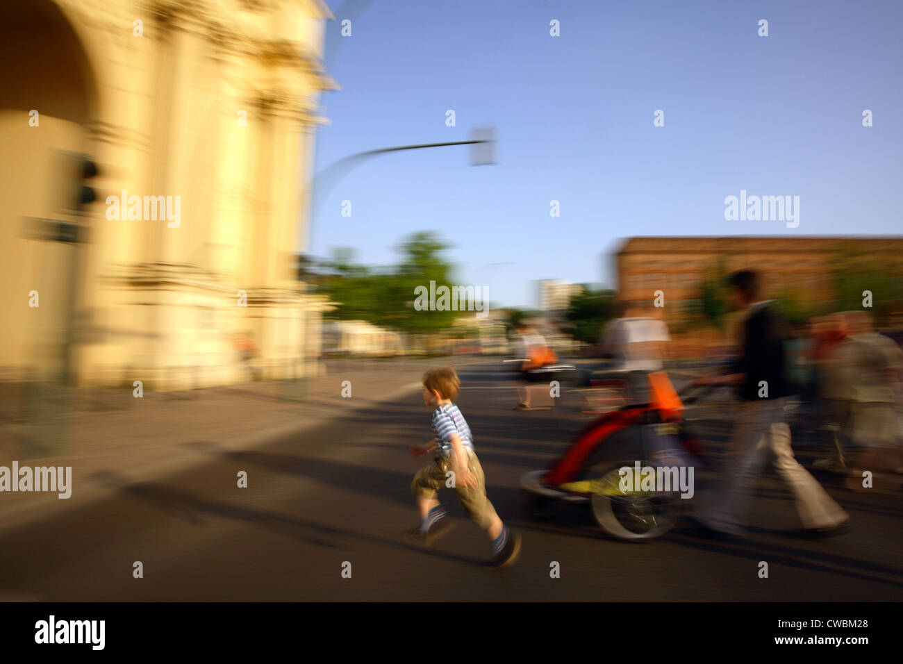 Child running across the road Stock Photo - Alamy