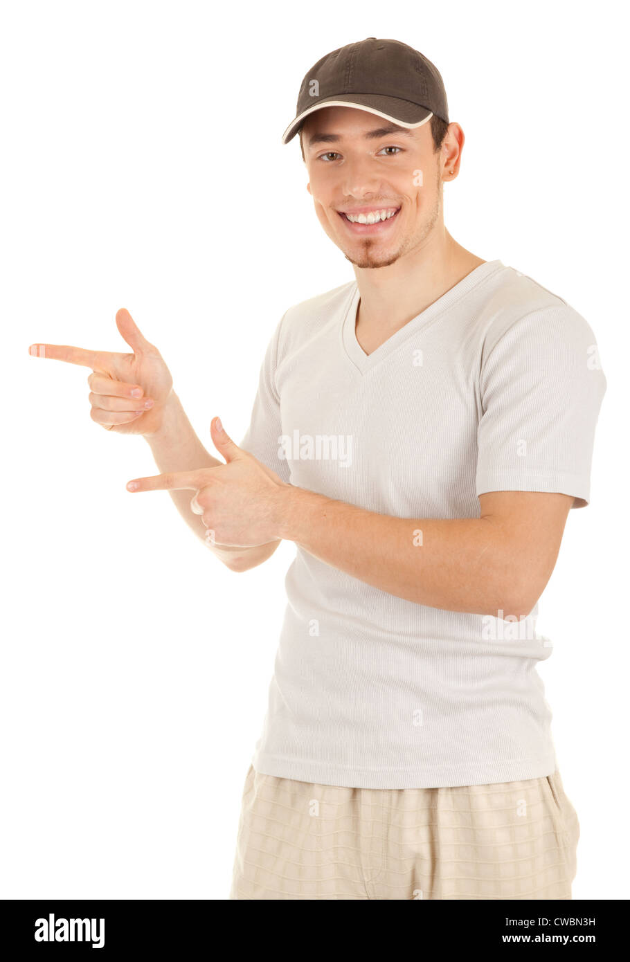 Smiling young man in a hat is pointing sideways. Isolated on white ...
