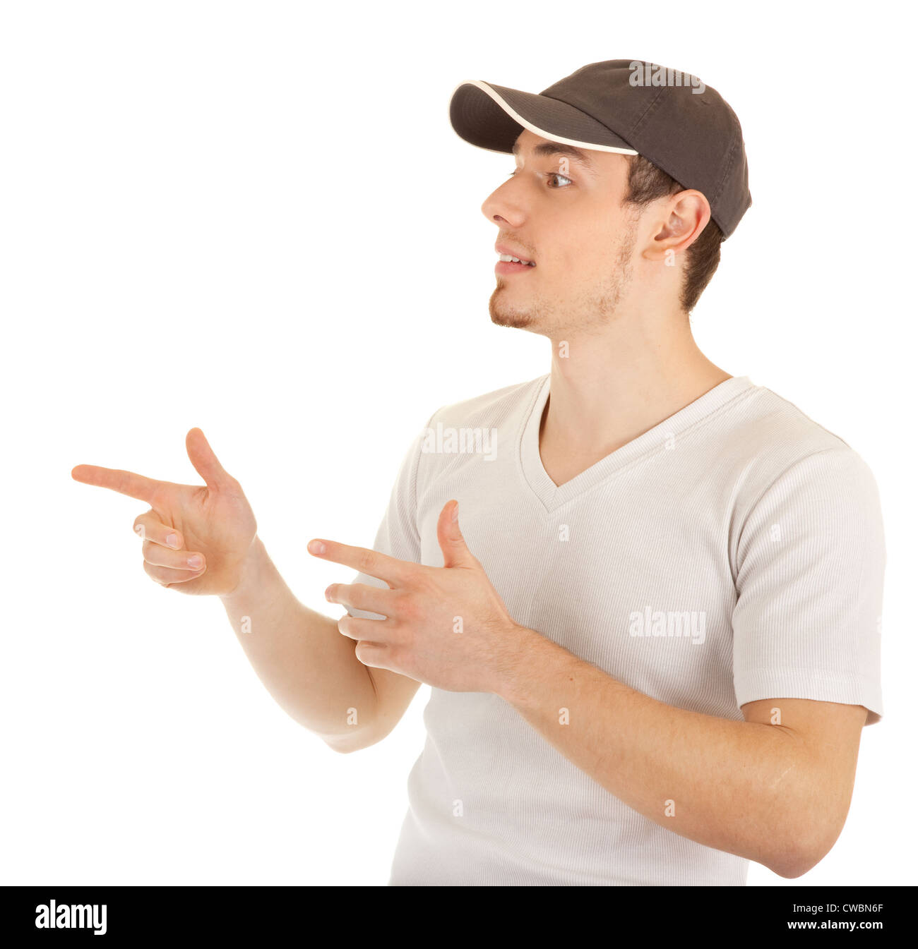 Casual young man in a hat is pointing sideways. Isolated on white Stock ...