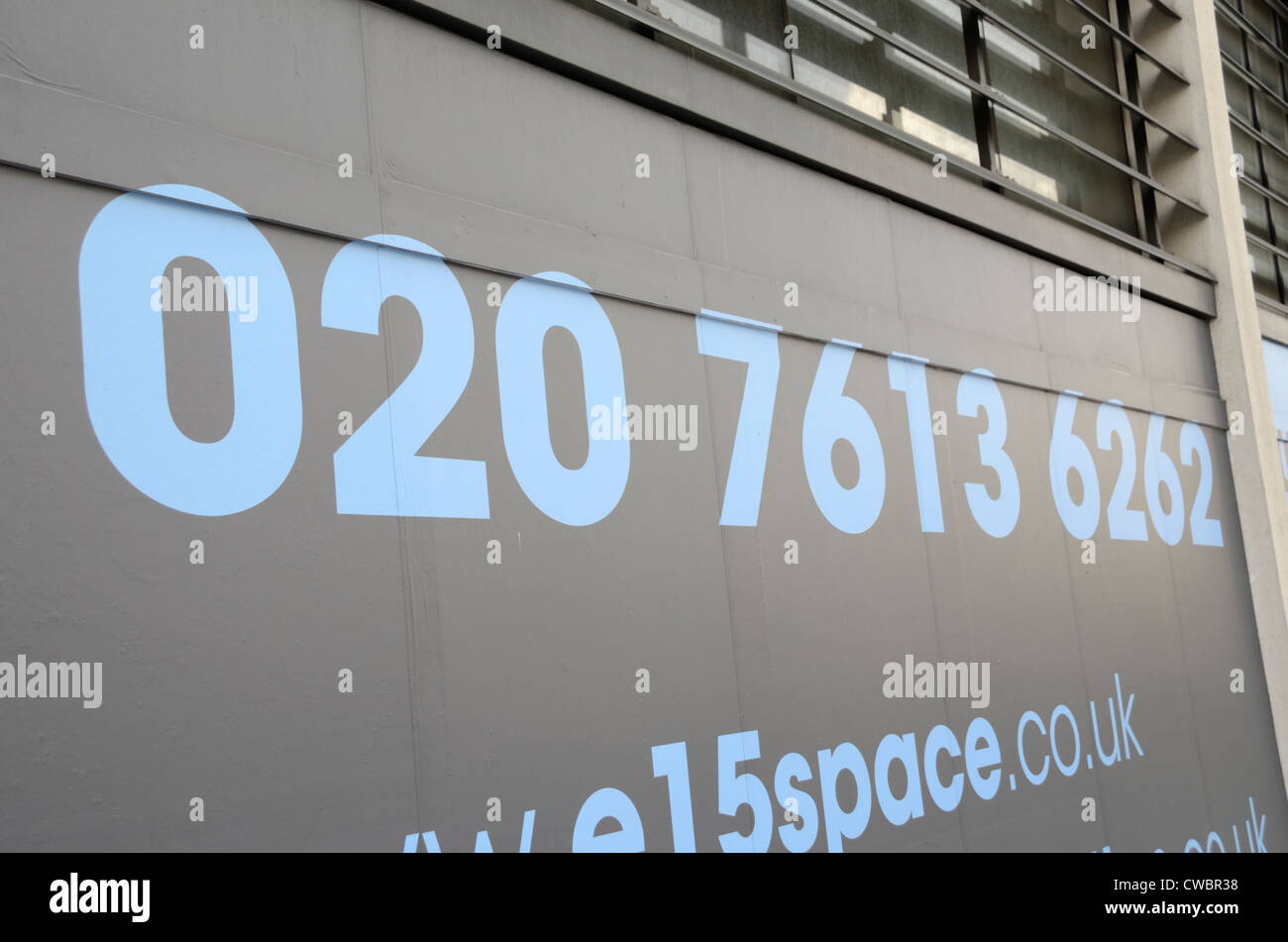 Outer London telephone number on the side of a commercial building ...