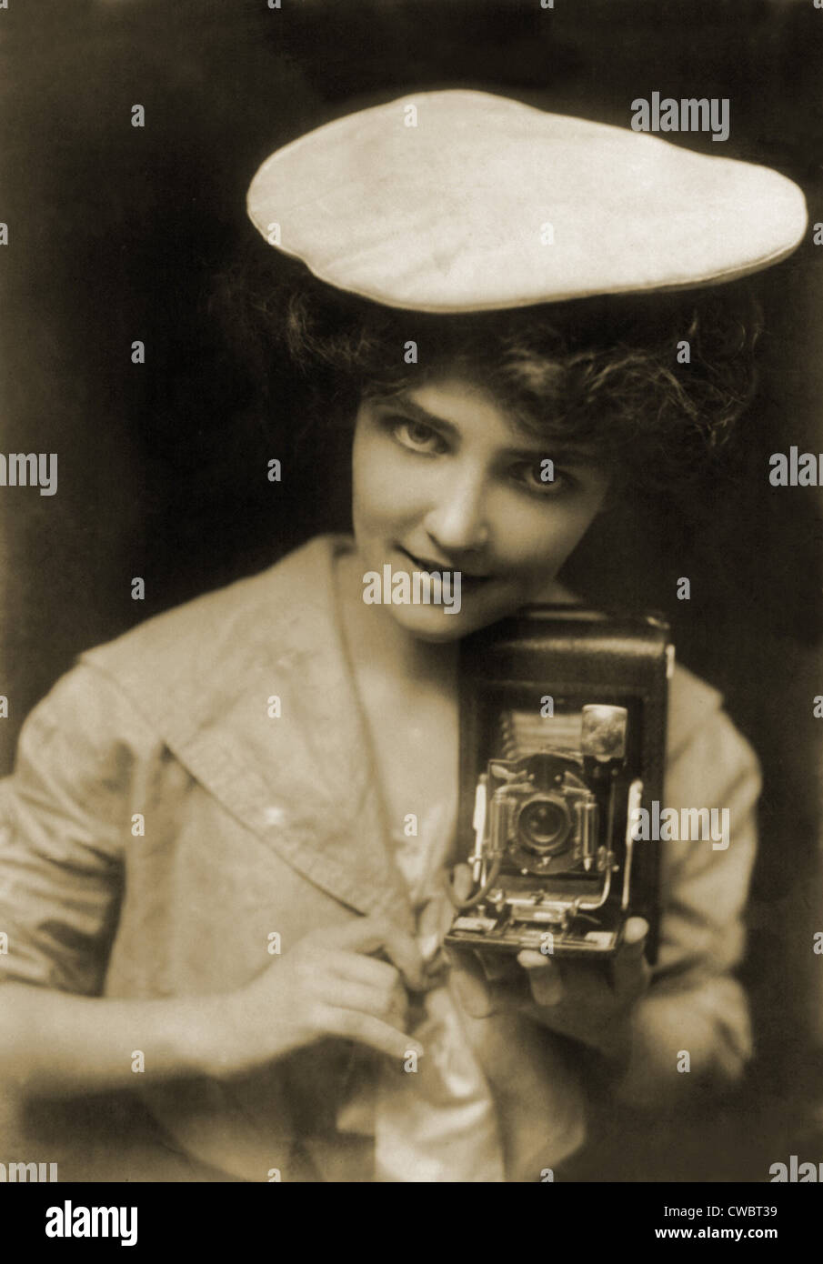 THE KODAK GIRL, a pretty girl posed with camera in a 1909 Kodak ...