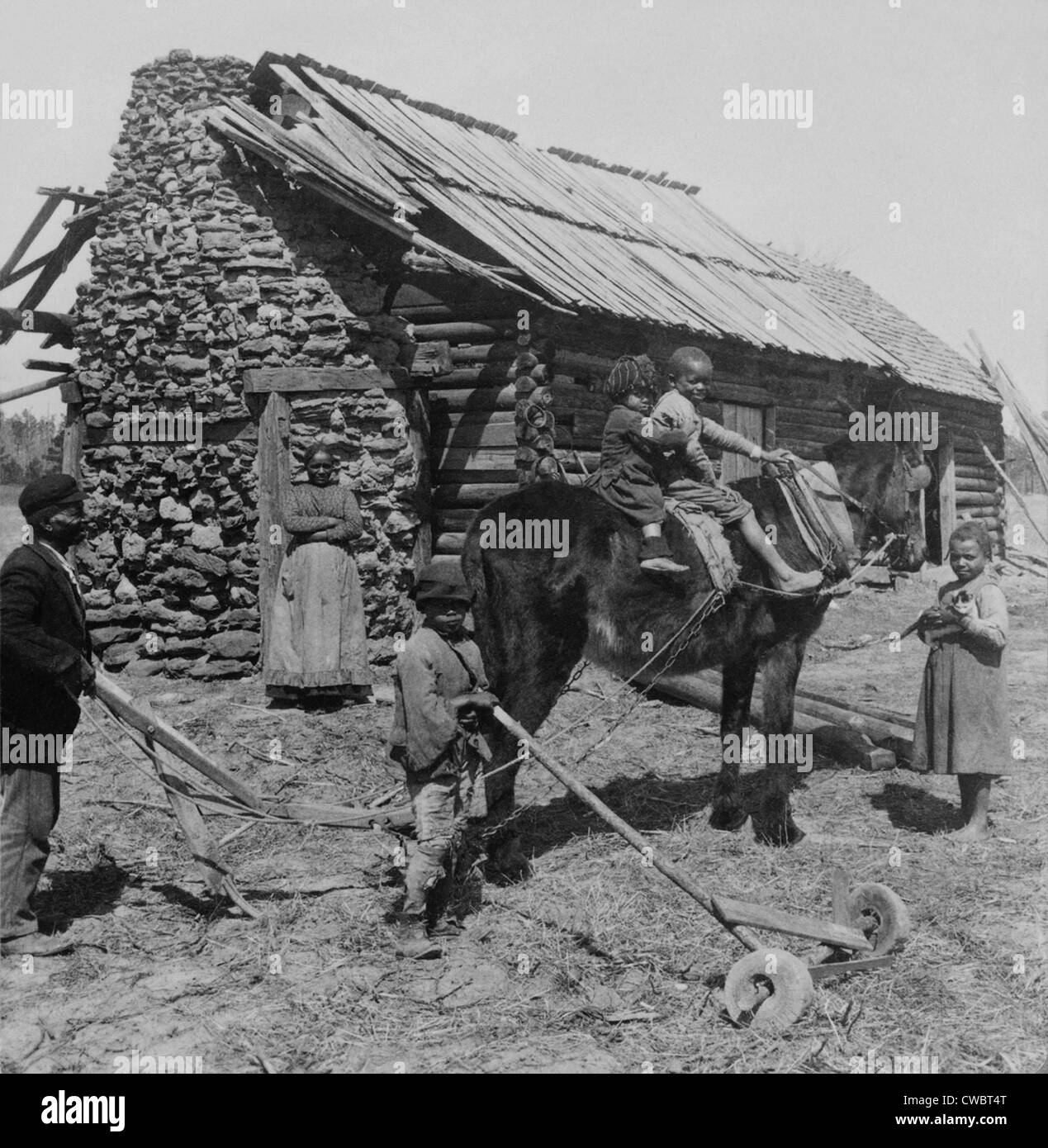 African American farm family outside their log cabin home in North ...