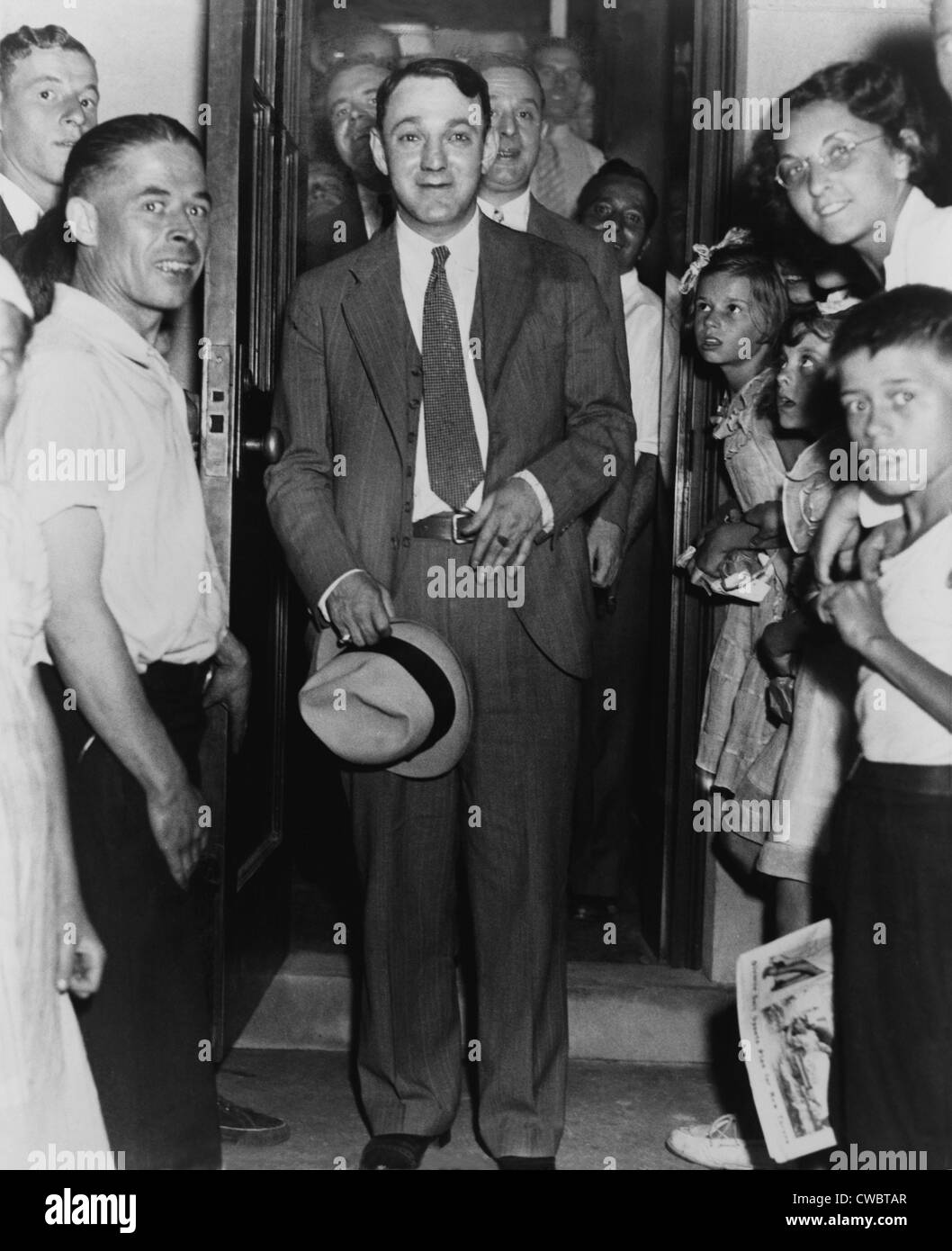 Dutch Schultz, emerging from doorway of Malone County jail, in an ...