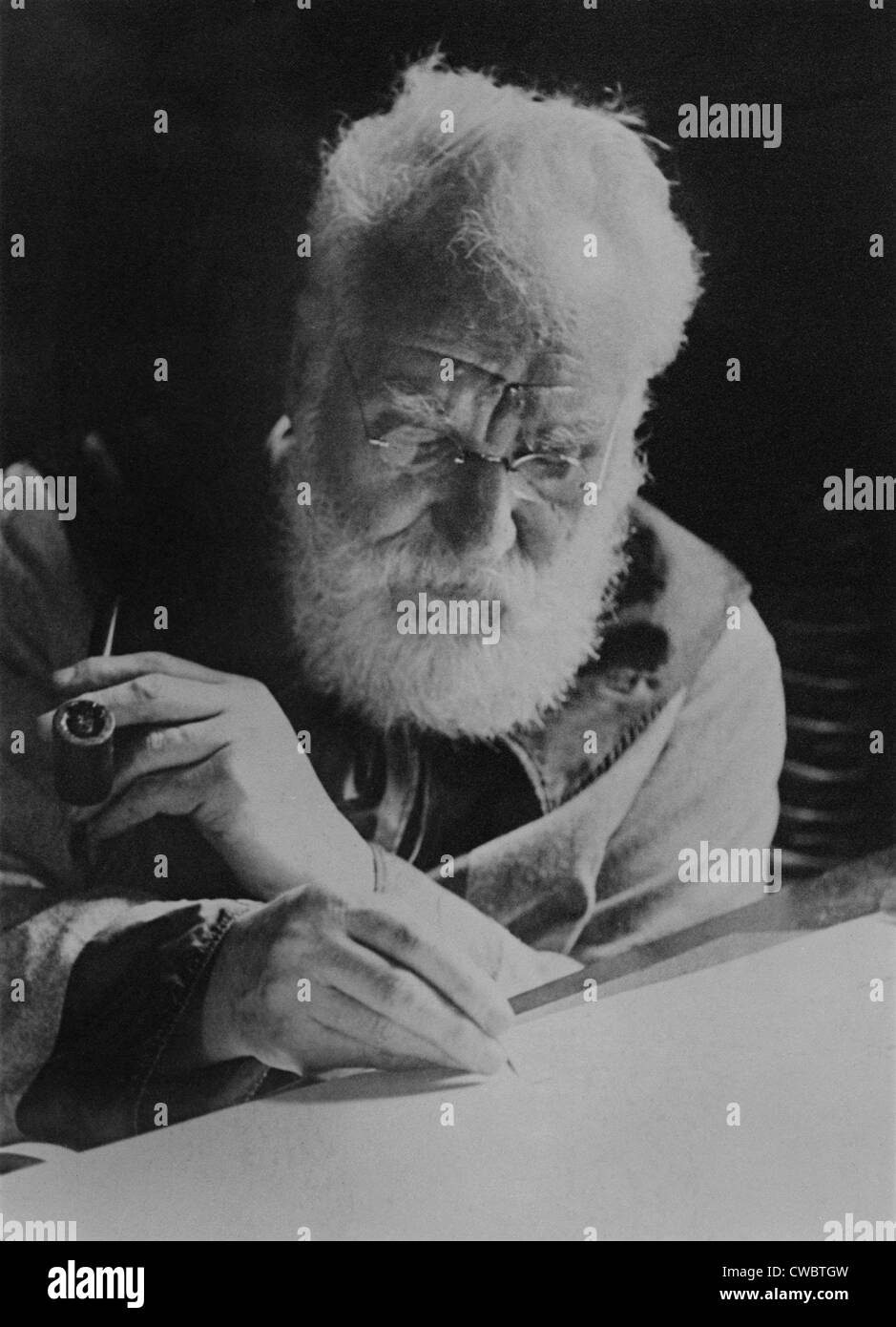 Alexander Graham Bell (1847-1922), writing at his desk in his study in ...