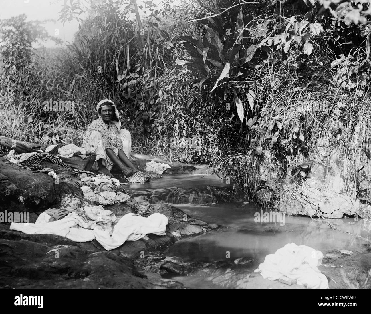 Puerto Ricans women washing laundry in an open stream shortly after ...