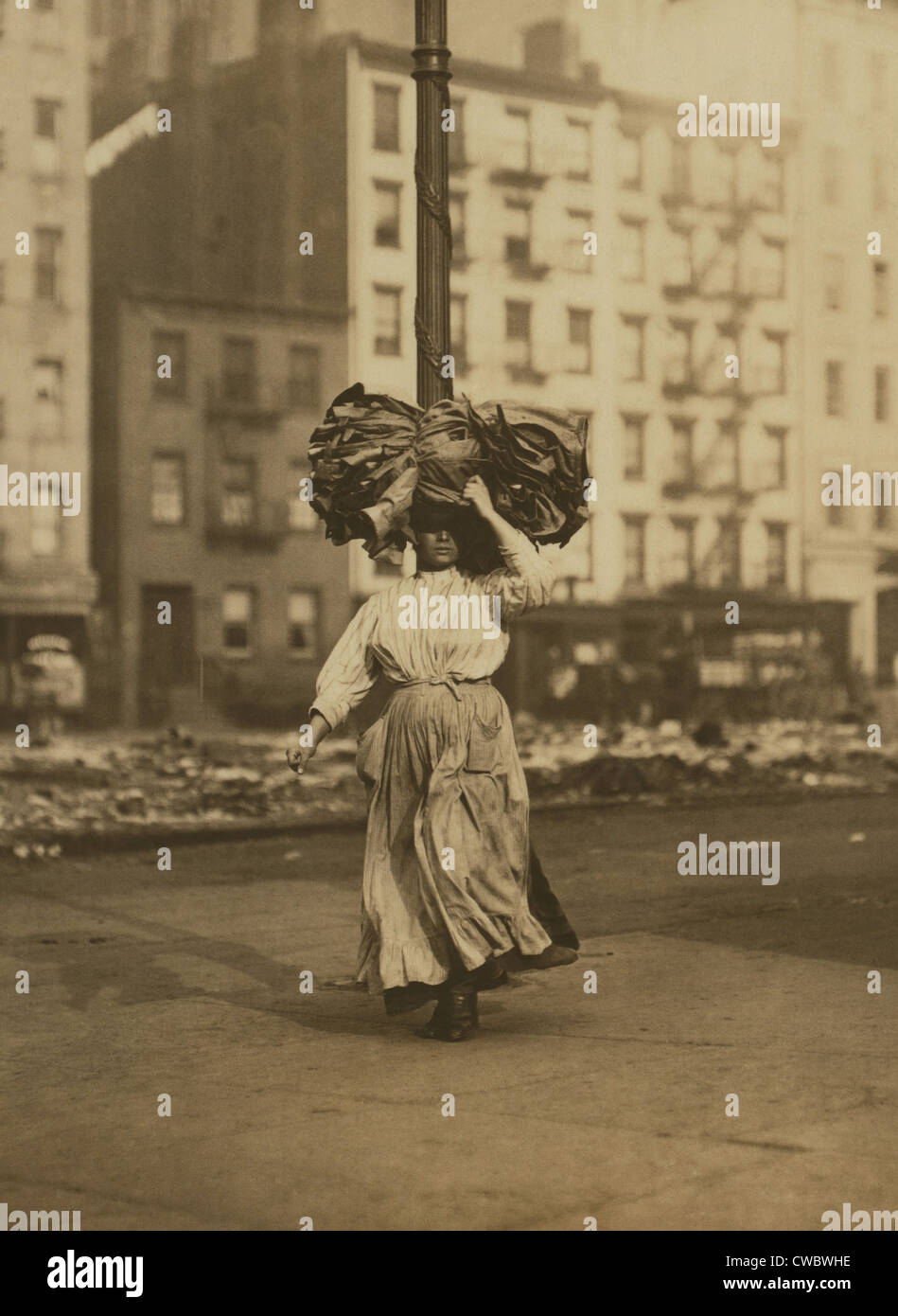 Italian woman carrying heavy bundle of clothing on her head Near Astor ...