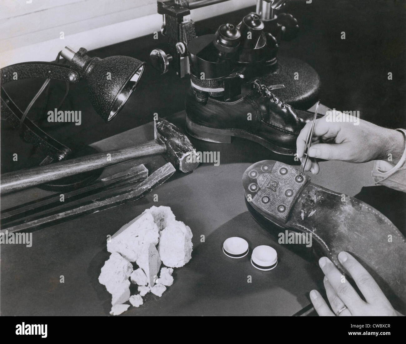 FBI forensic science. A technician removing safe insulation from the ...