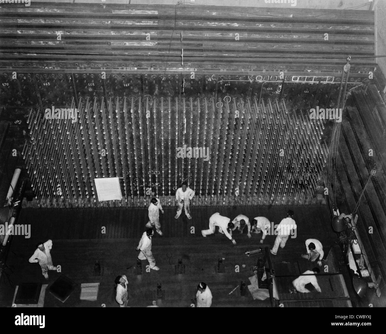 Workers laying up the graphite core of the Reactor-B atomic pile. The ...