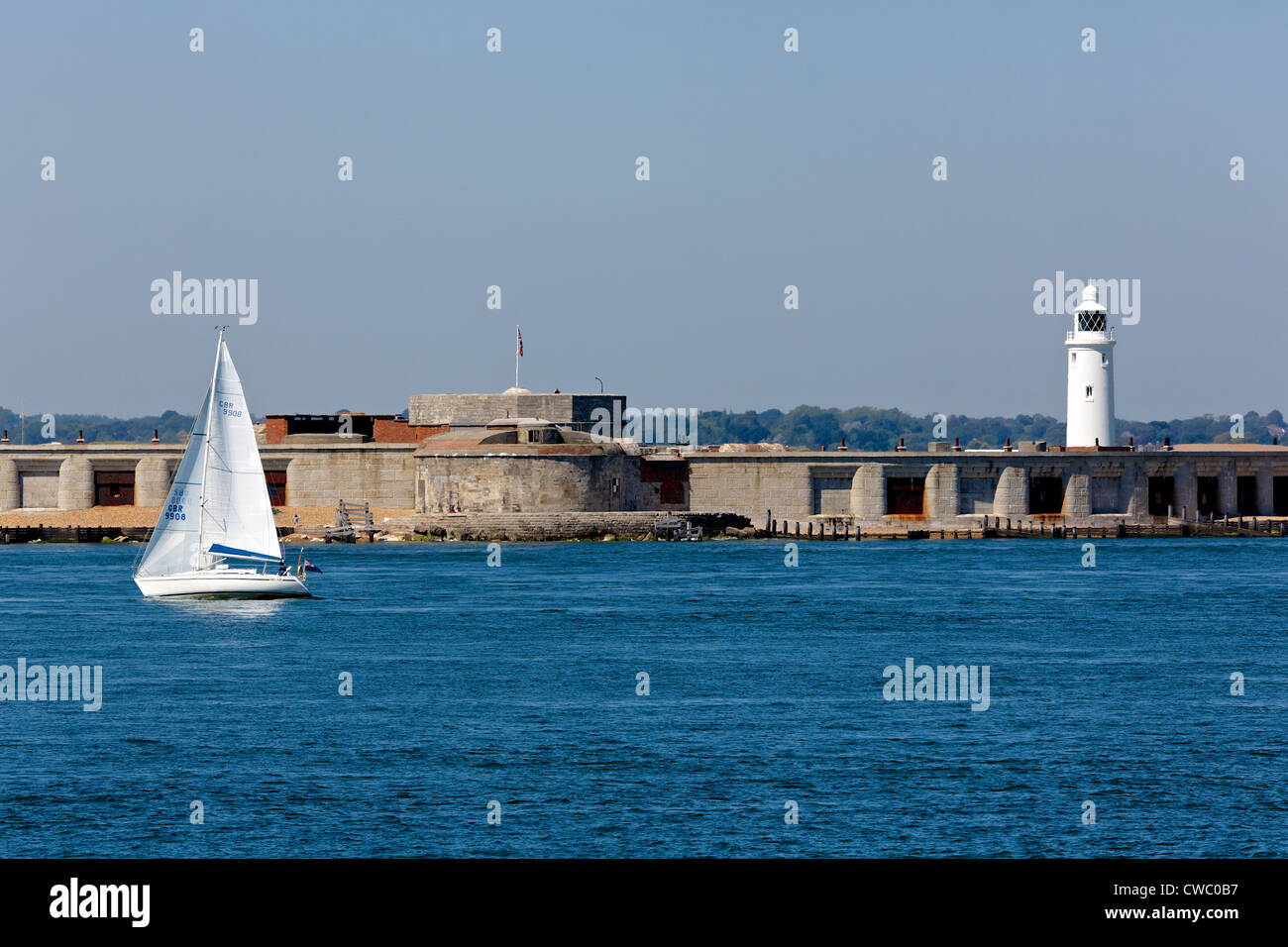 Sail boat passes in front of Hurst Castle and lighthouse, Hurst Point ...
