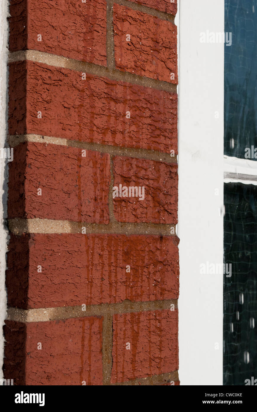 Water trickling down brick wall next to window Stock Photo - Alamy