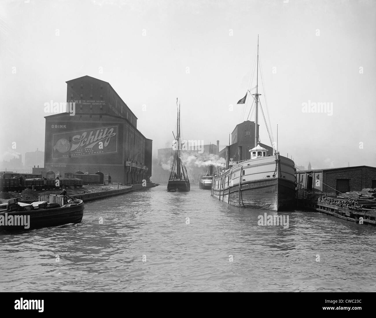 Cargo ships in the Chicago River. Warehouses and grain elevators line ...