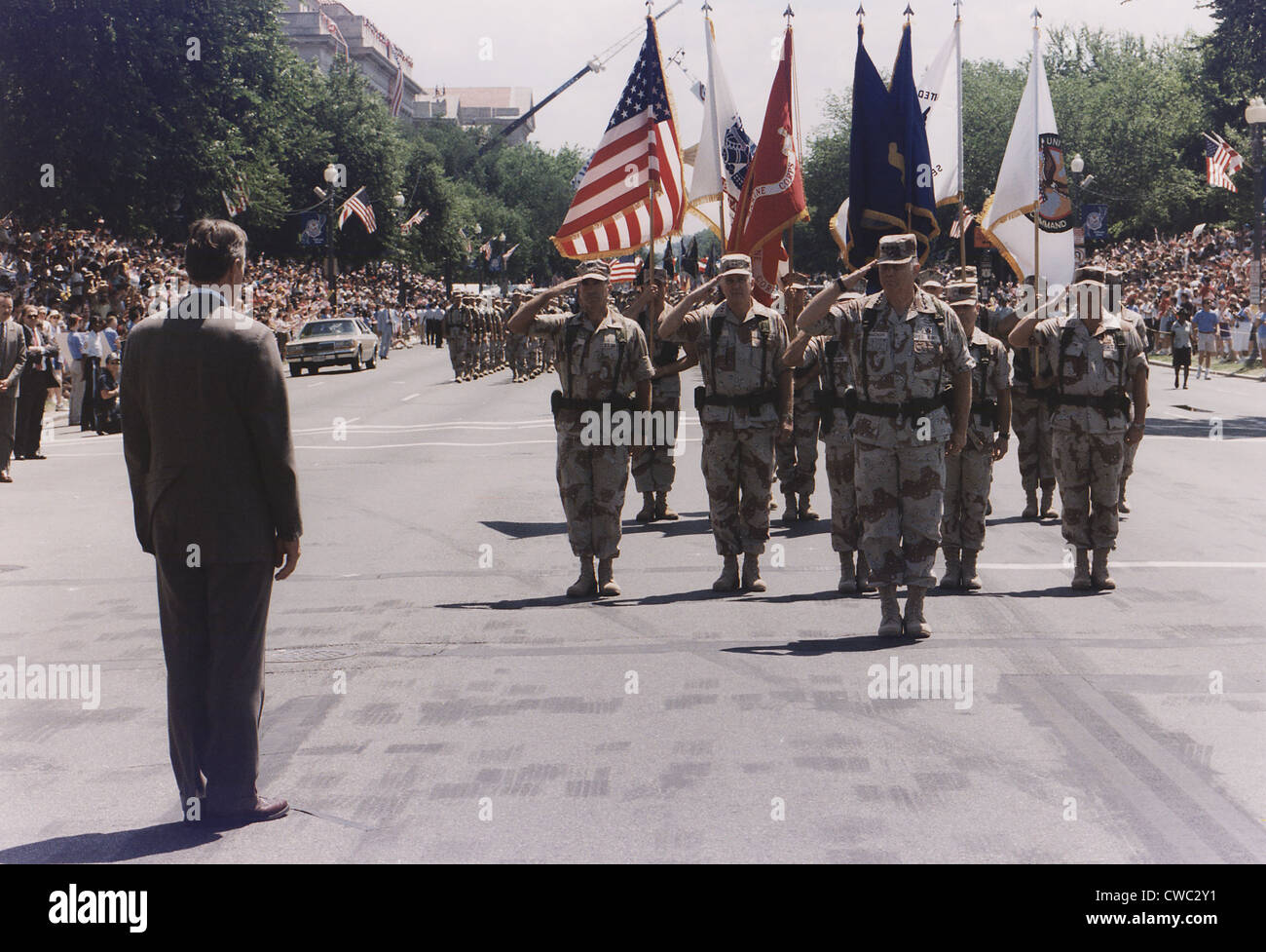 President Bush at a Desert Storm Homecoming Parade receives a salute ...