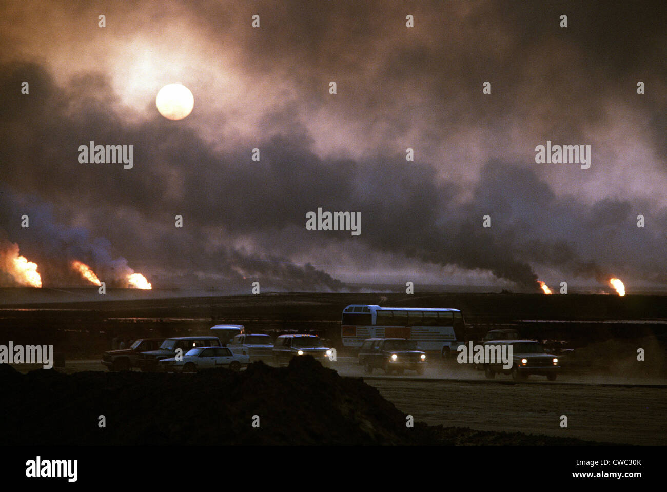 The smoke from oil well fires forces Kuwait drivers to use their ...