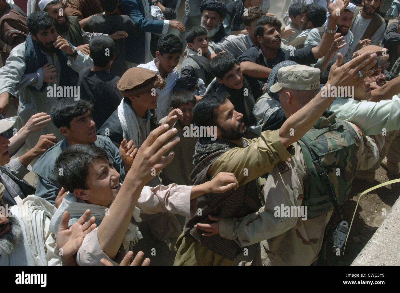 U.S. Army soldiers maintain order as local villager's struggle to reach ...