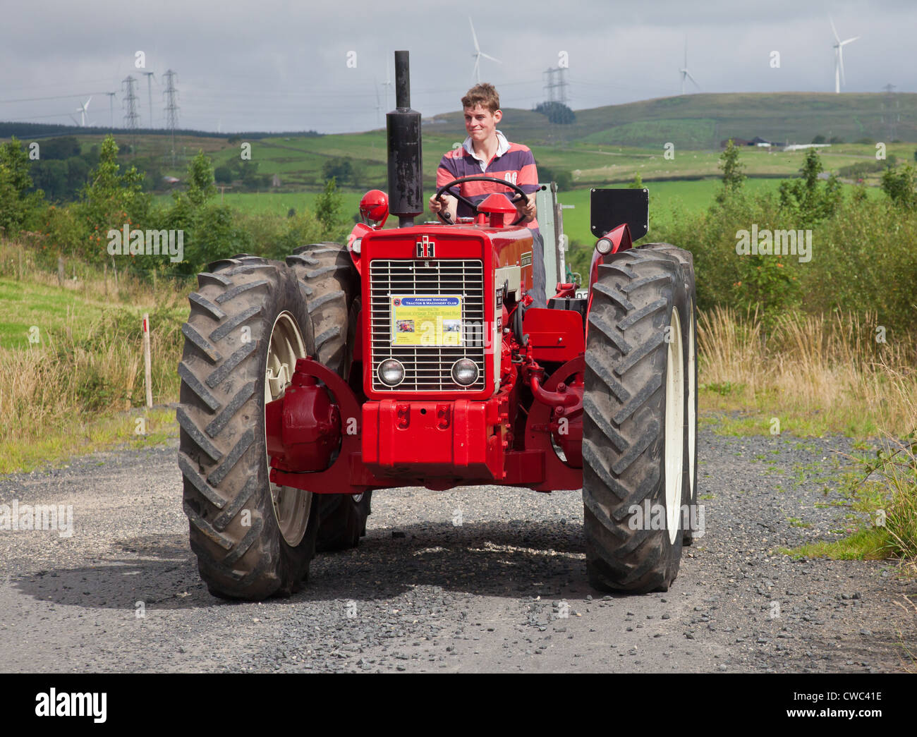 Enthusiast driving a vintage International 634 All-wheel Drive tractor ...