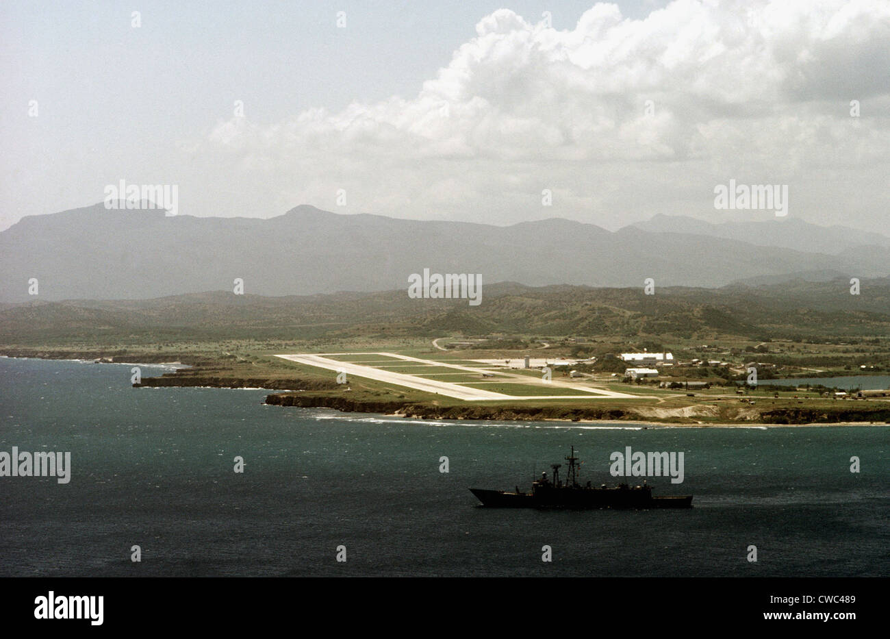 The guided missile frigate USS STARK lower right heads out to sea from ...