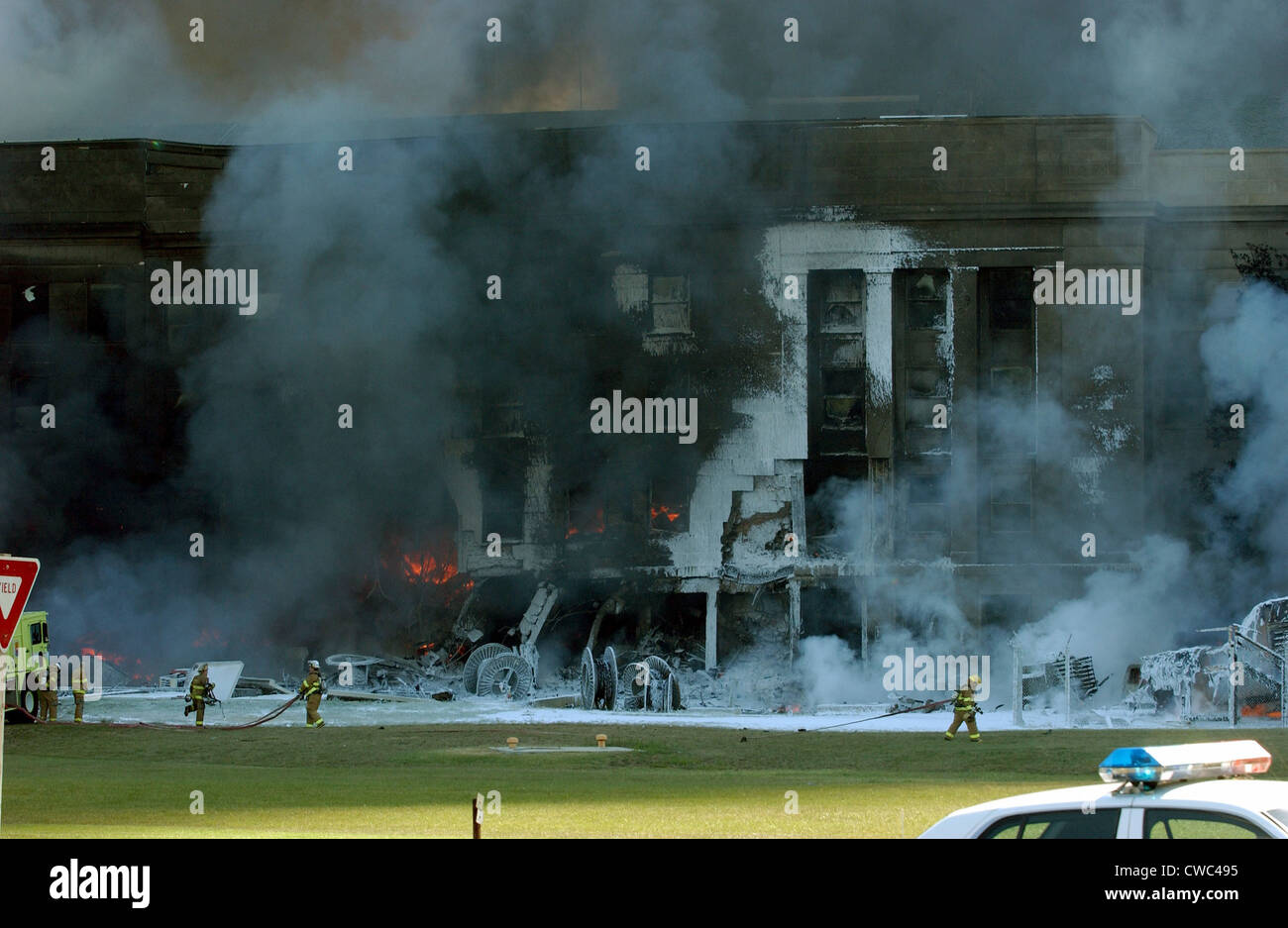 Firefighters work to put out the flames moments after a hijacked ...