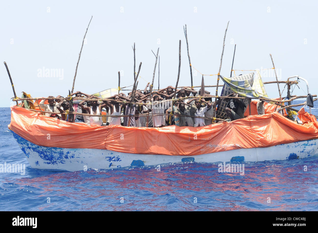 Primitive boat crowded with suspected pirates under arrest and awaiting ...