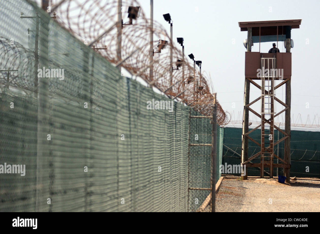 U.S. Soldier stands watch in a guard tower at Camp Delta in Guantanamo ...