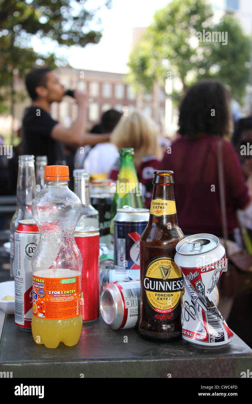 Table with empty bottle and drink cans littering streets Stock Photo ...