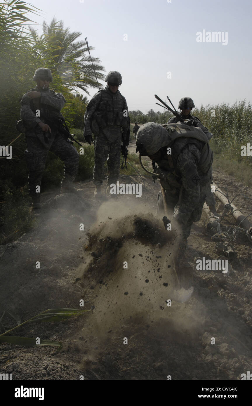 US Army Soldiers search for buried weapons at a remote village outside ...