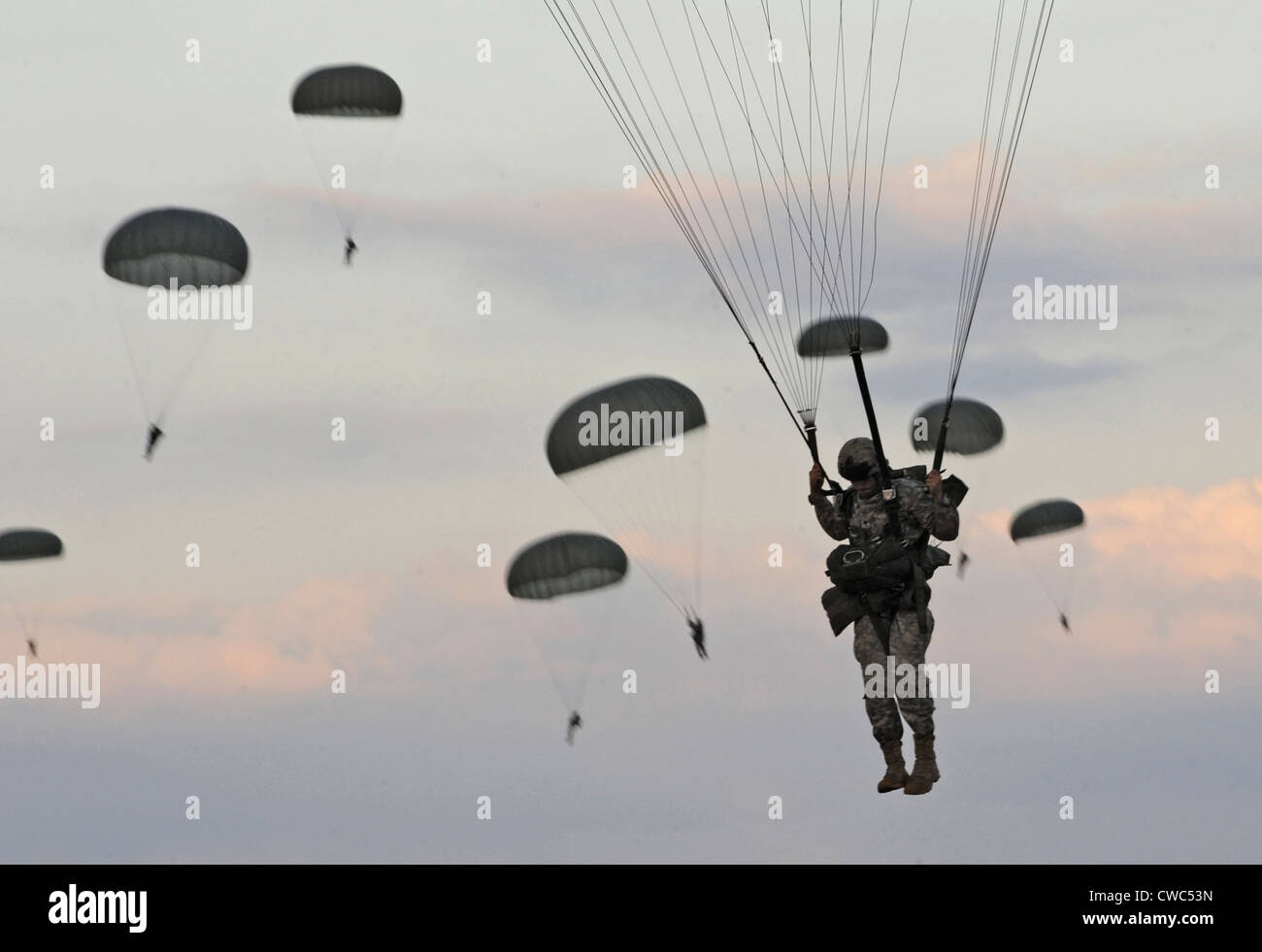 Soldiers of the 82nd Airborne descend from a parachute drop during ...