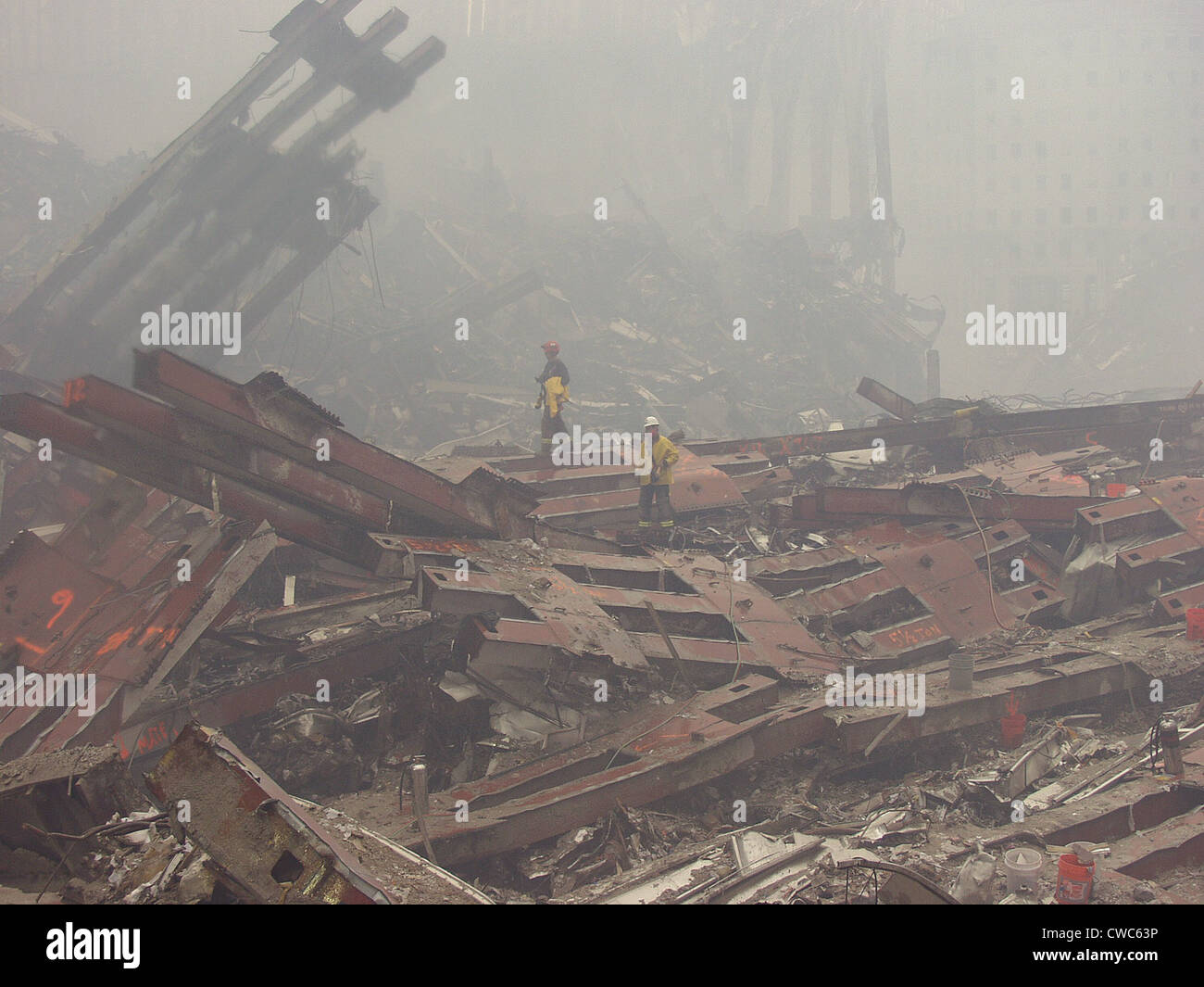 Rescue workers walk over 'The Pile' of the ruins of the World Trade ...