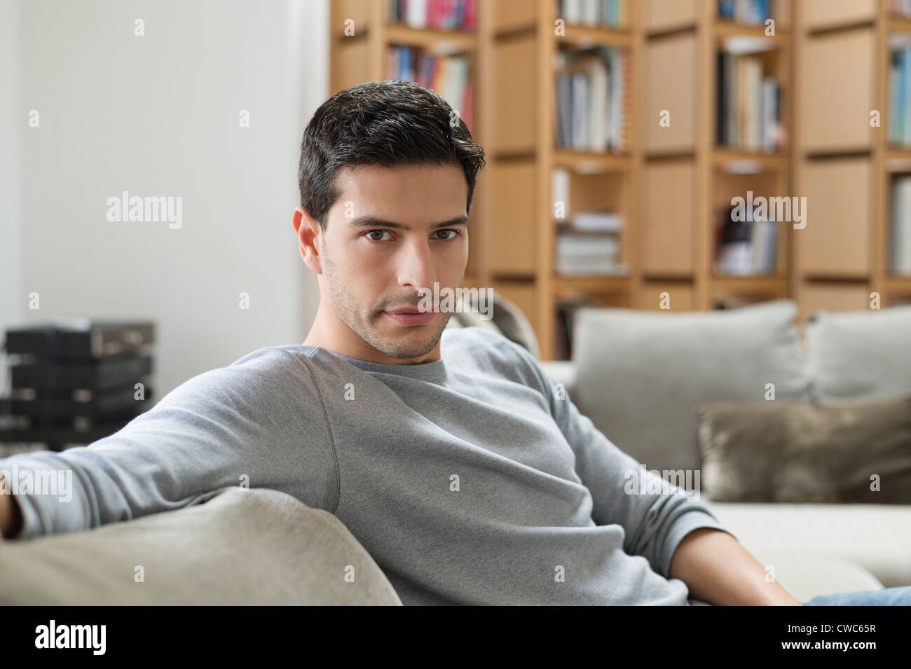 Man resting on a couch Stock Photo - Alamy
