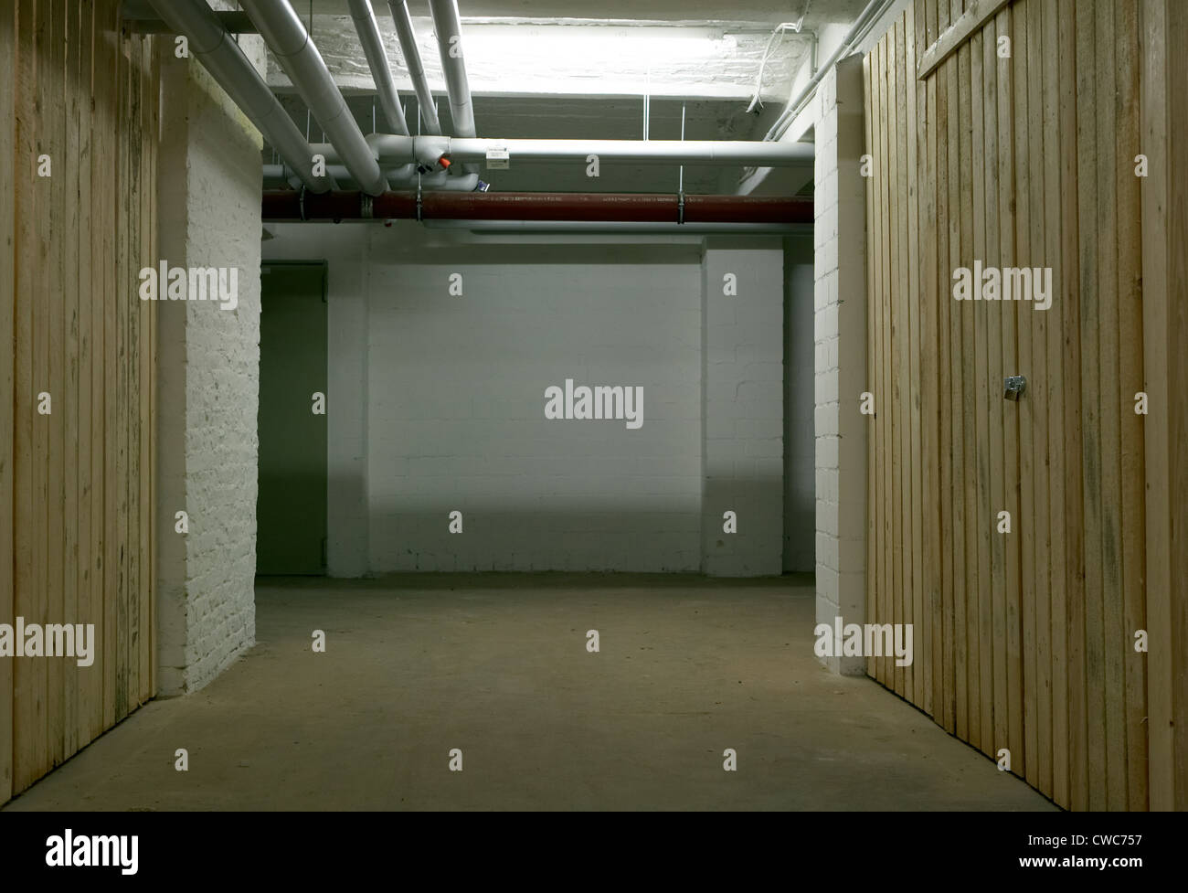Passage in a basement with cellar compartments Stock Photo - Alamy