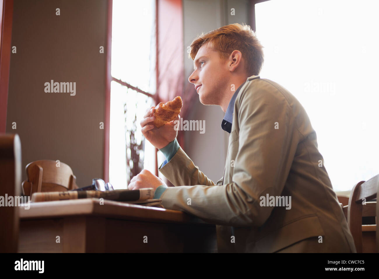 Man eating croissant Stock Photo - Alamy