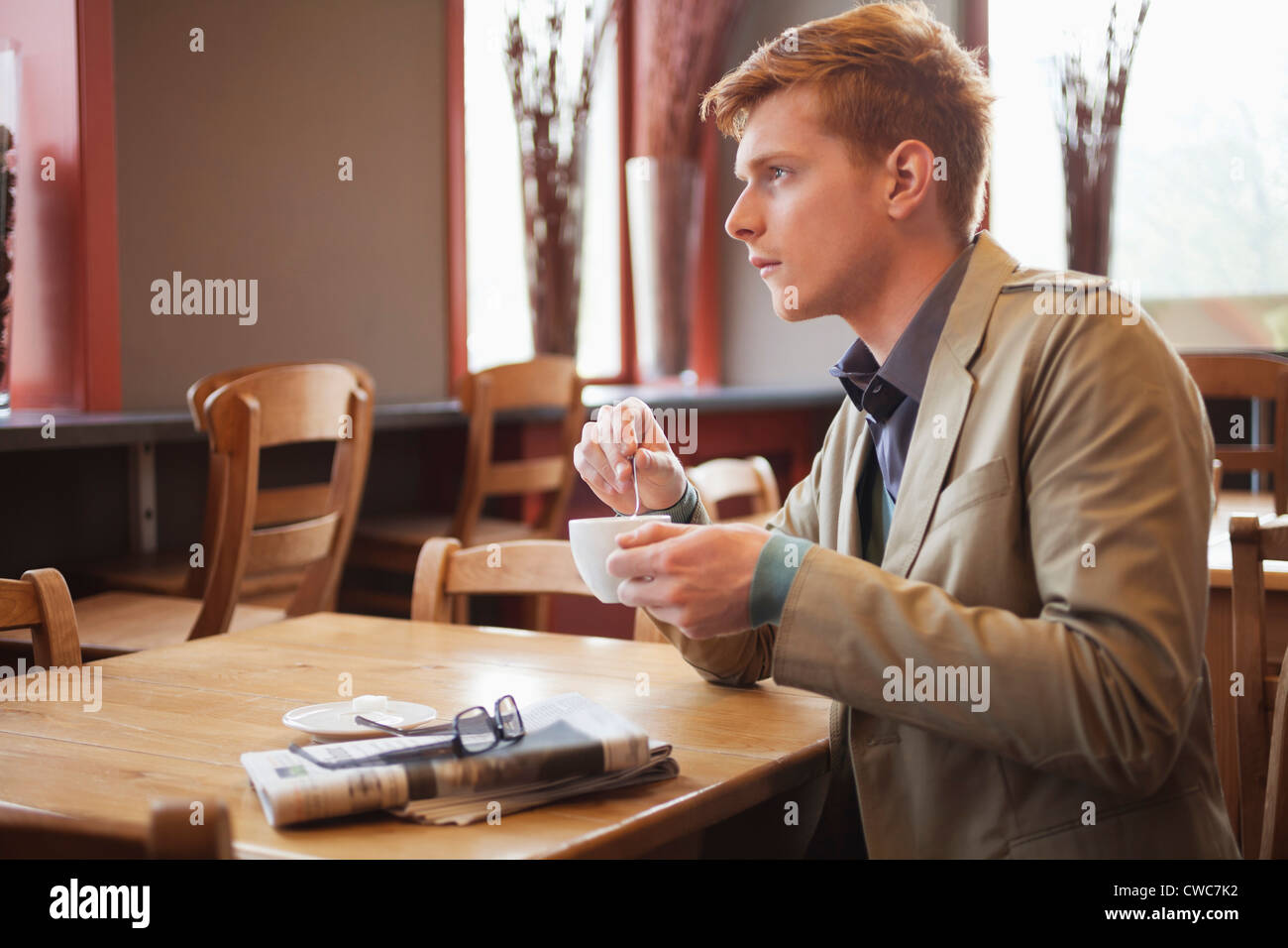 Man drinking tea in a restaurant Stock Photo - Alamy