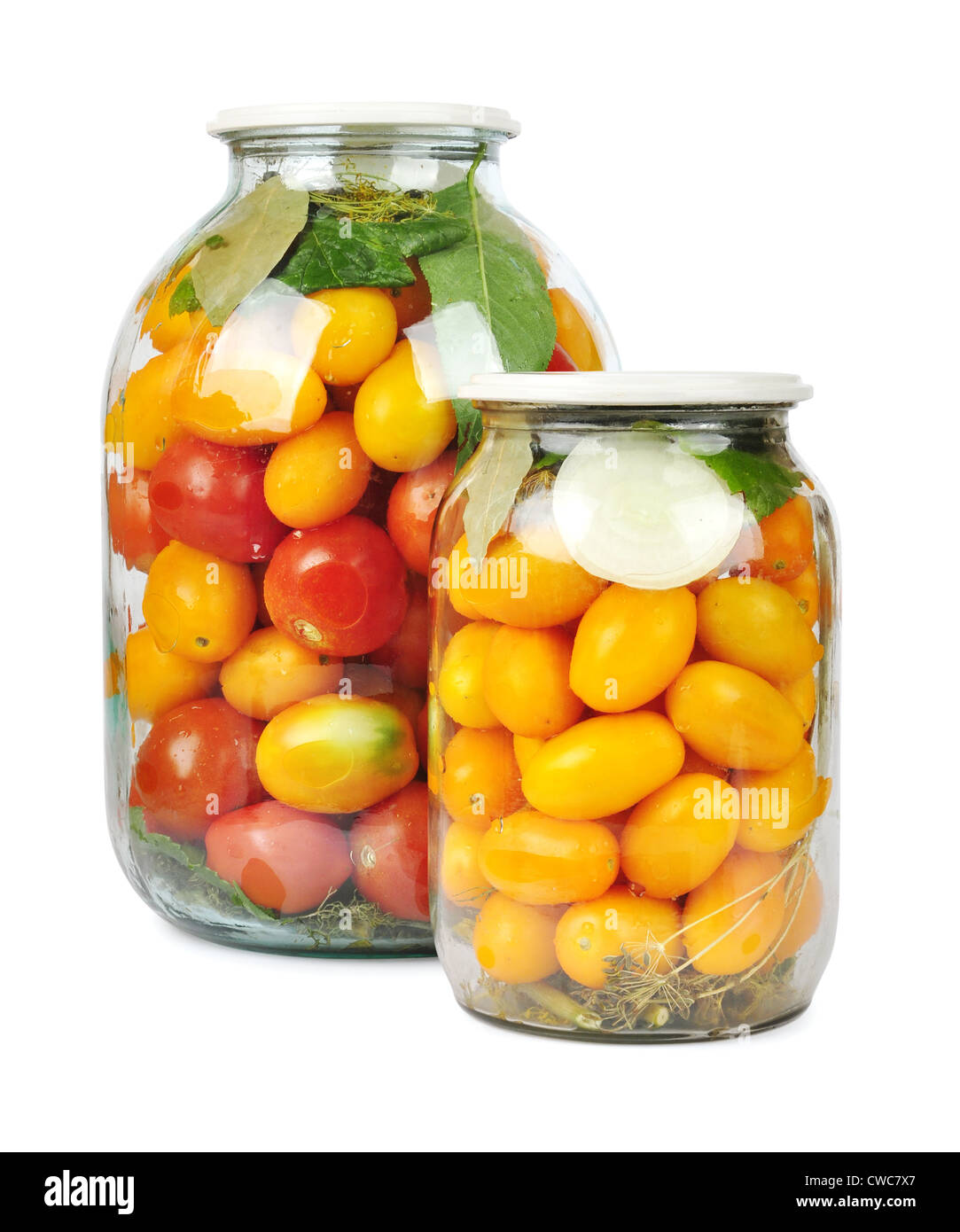 Preserved red and yellow tomatoes in a glass jar isolated on white ...