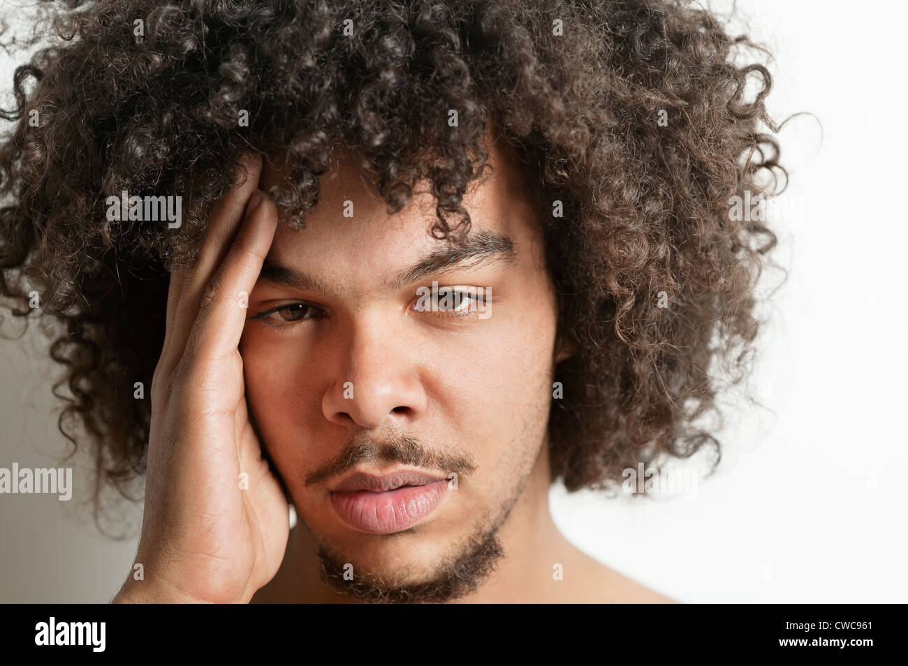 Portrait of young man having headache over white background Stock Photo ...