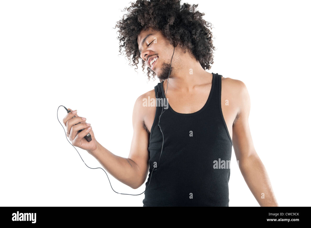 Happy young man listening to mp3 player over white background Stock ...