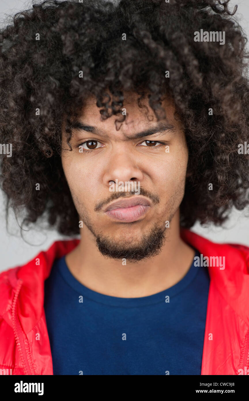 Portrait of a young man with raised eyebrow Stock Photo - Alamy