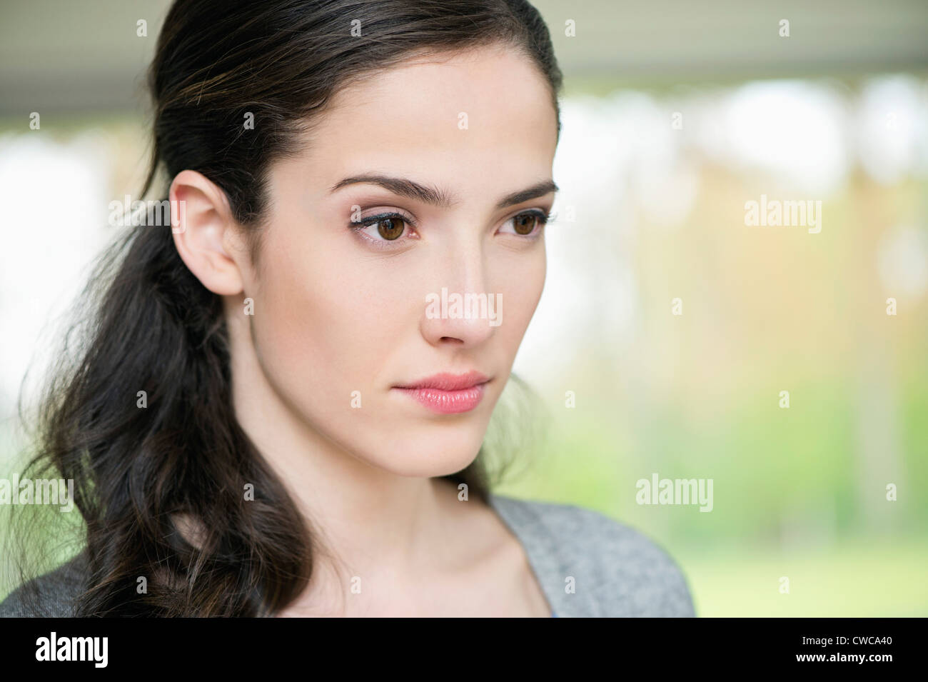 Close-up of a woman looking serious Stock Photo - Alamy