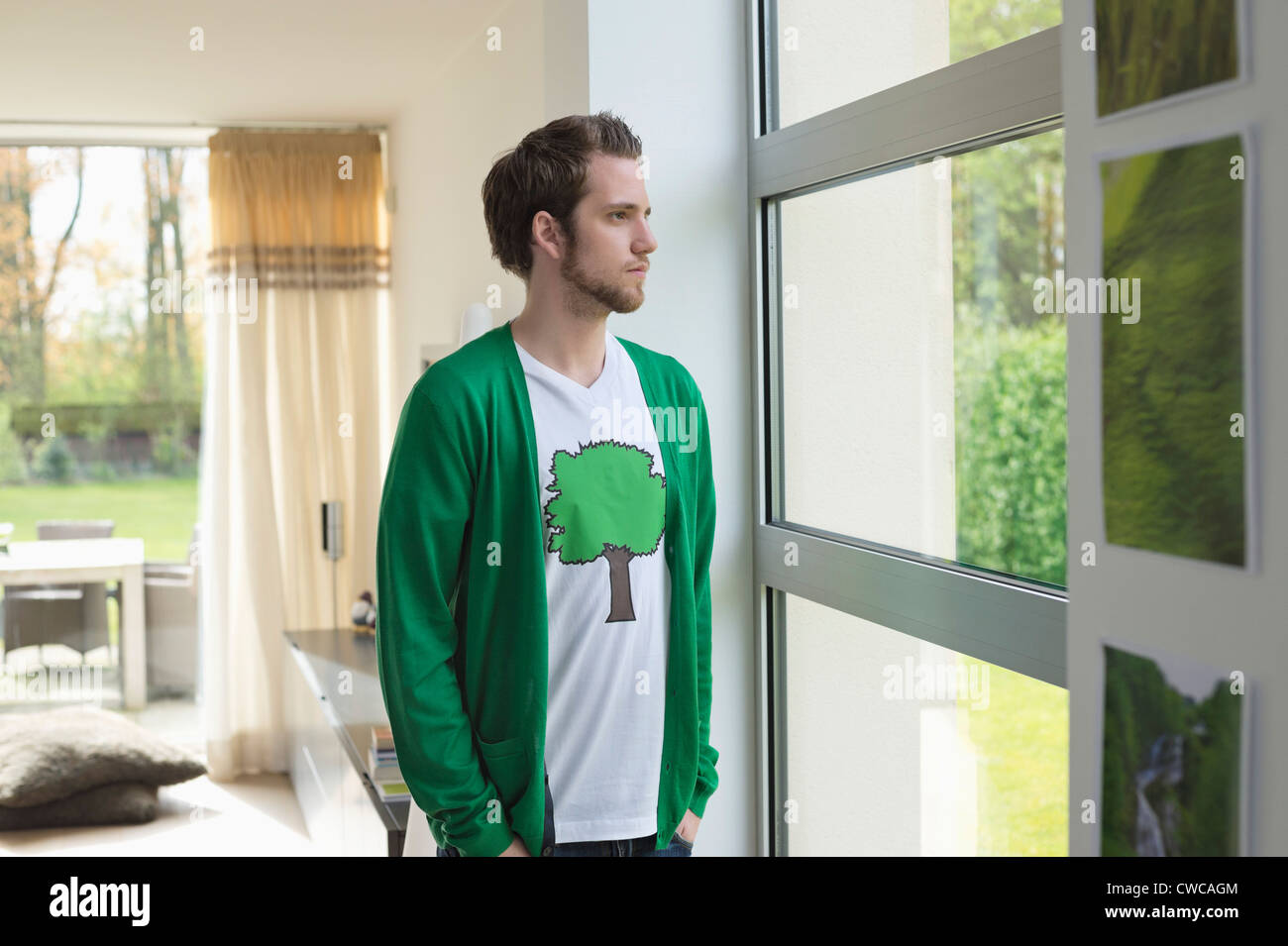 Man looking through a window Stock Photo - Alamy